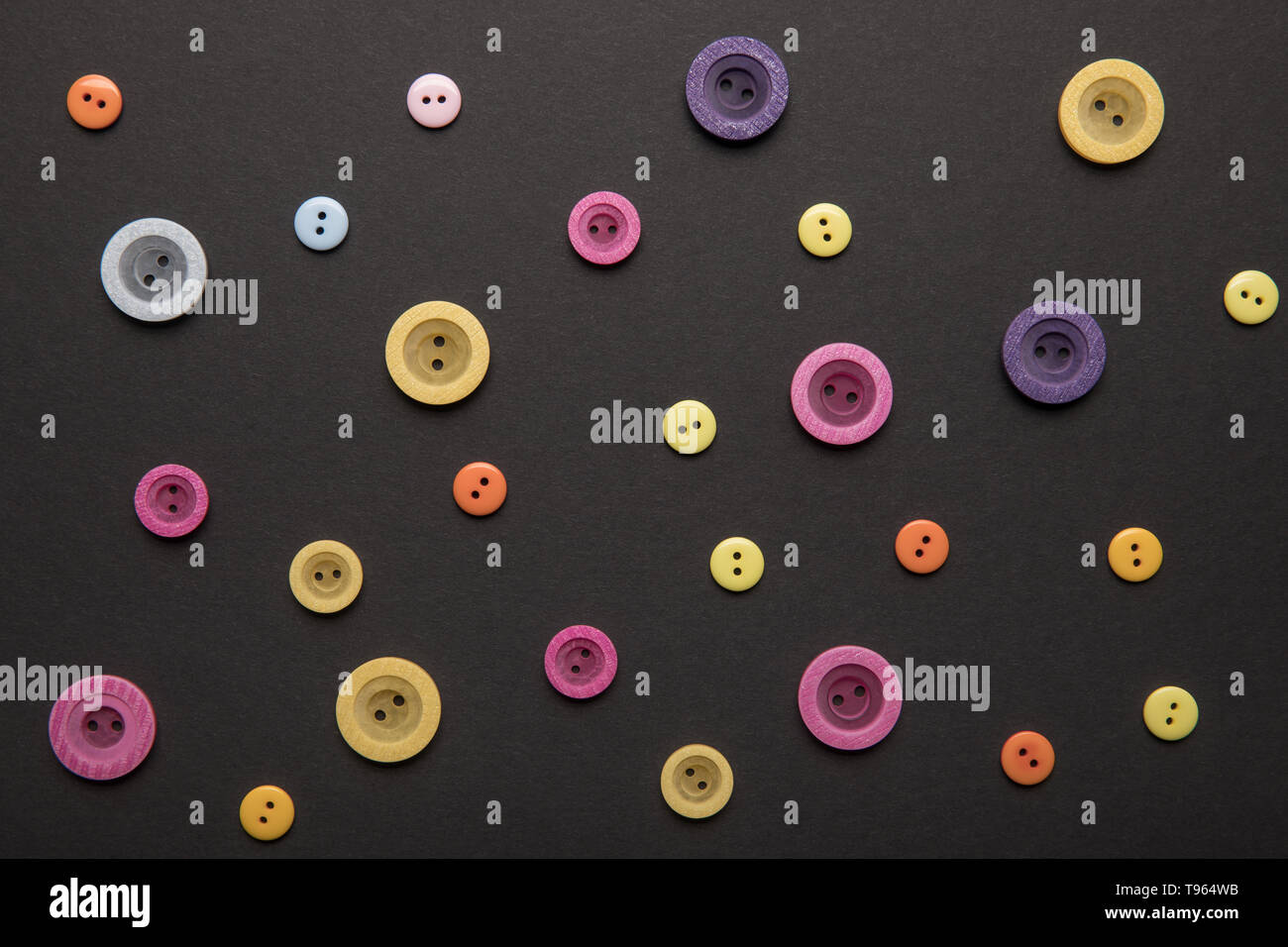 top view of various colorful clothing buttons isolated on black Stock ...