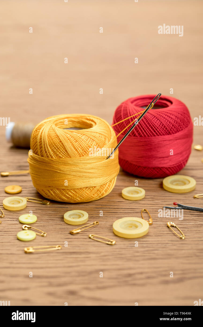 cotton knitting yarn balls with clothing buttons and safety pins on ...