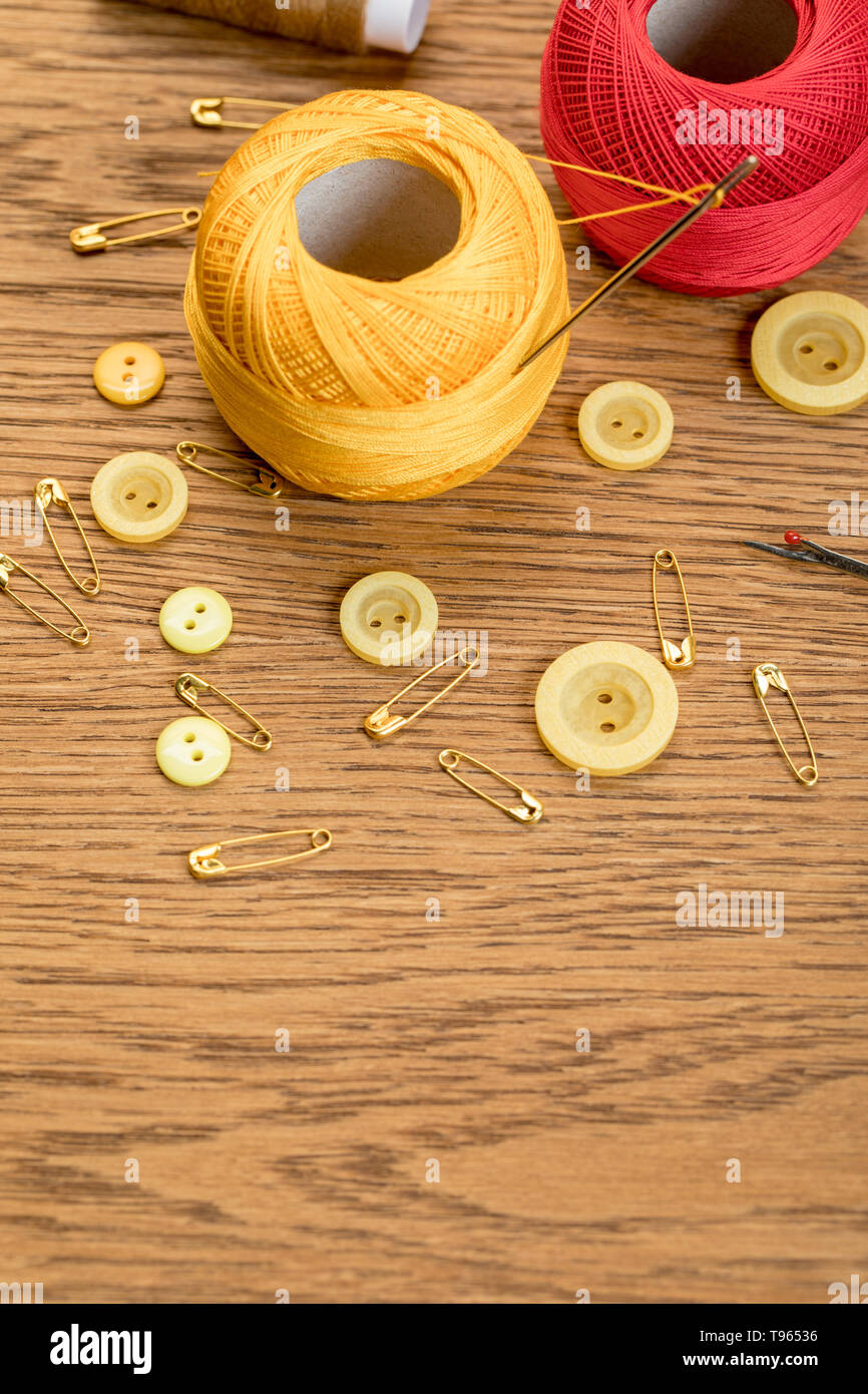 cotton knitting yarn balls with clothing buttons and safety pins on ...