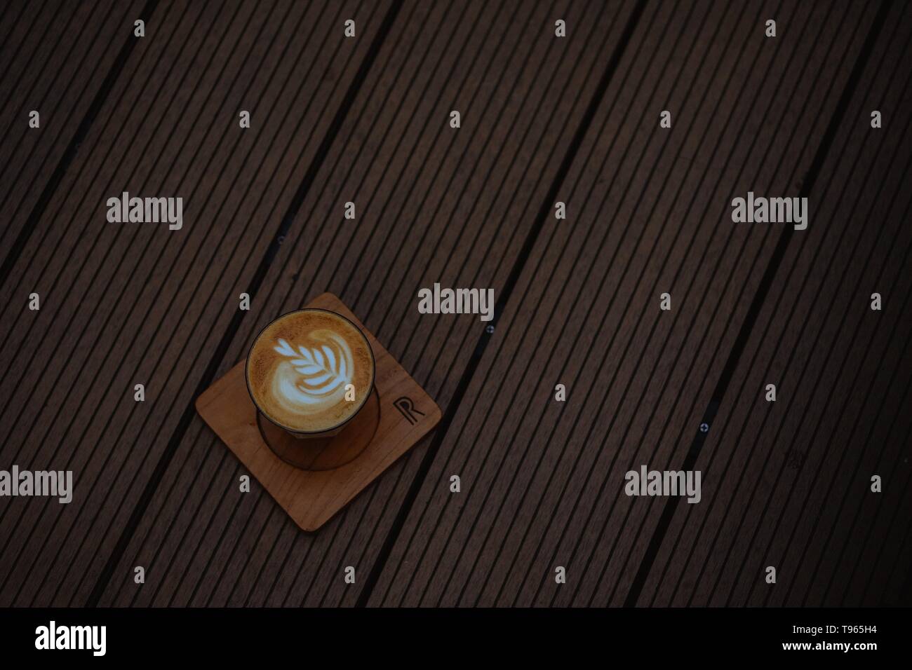 A cup of well made latte with art on foam Stock Photo - Alamy