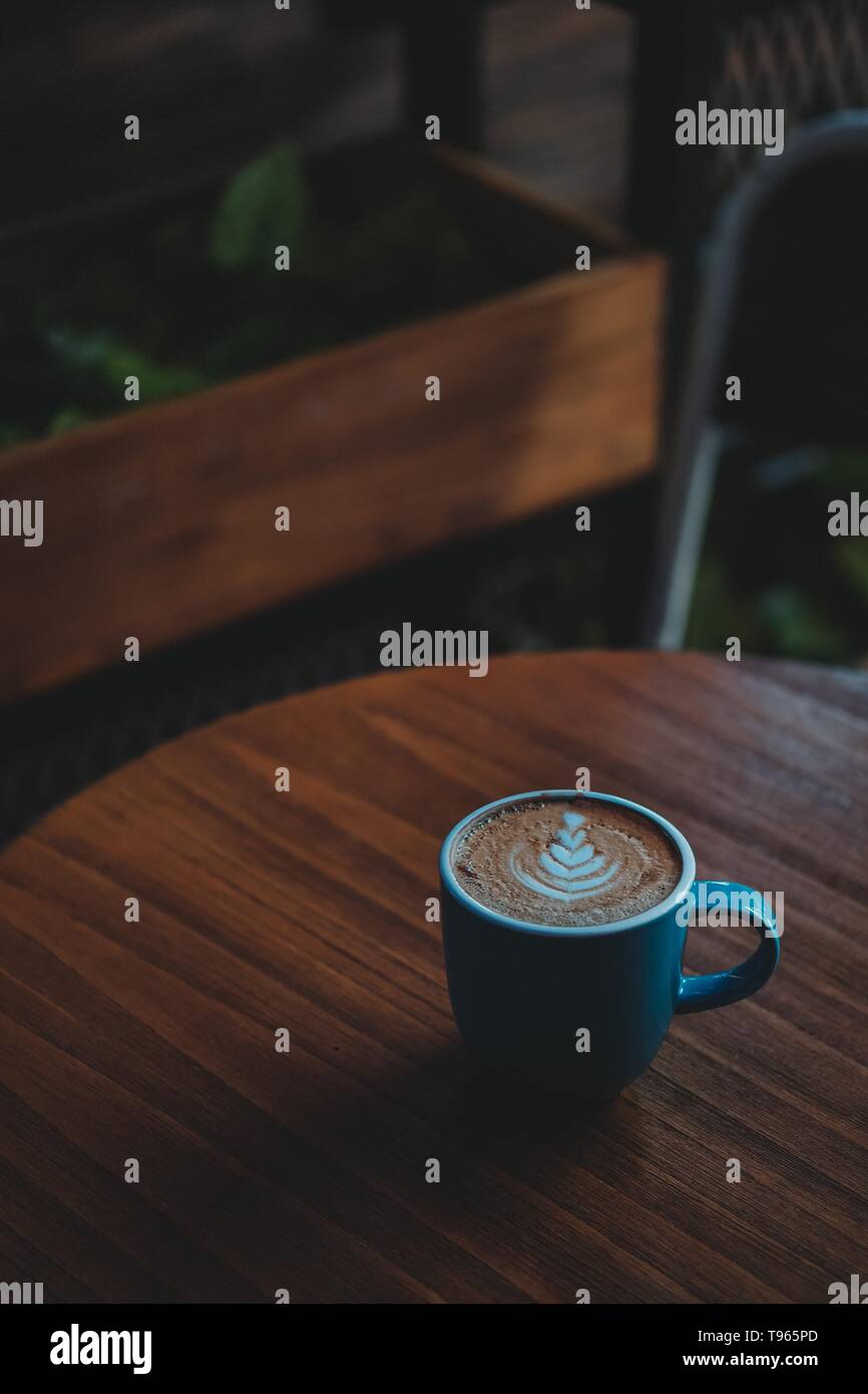 A cup of well made latte with art on foam Stock Photo - Alamy