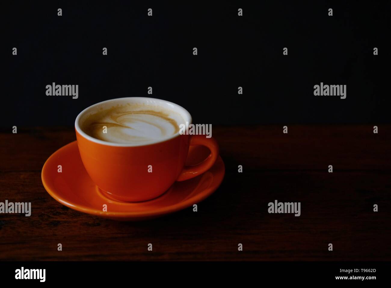 A cup of well made latte with art on foam Stock Photo - Alamy