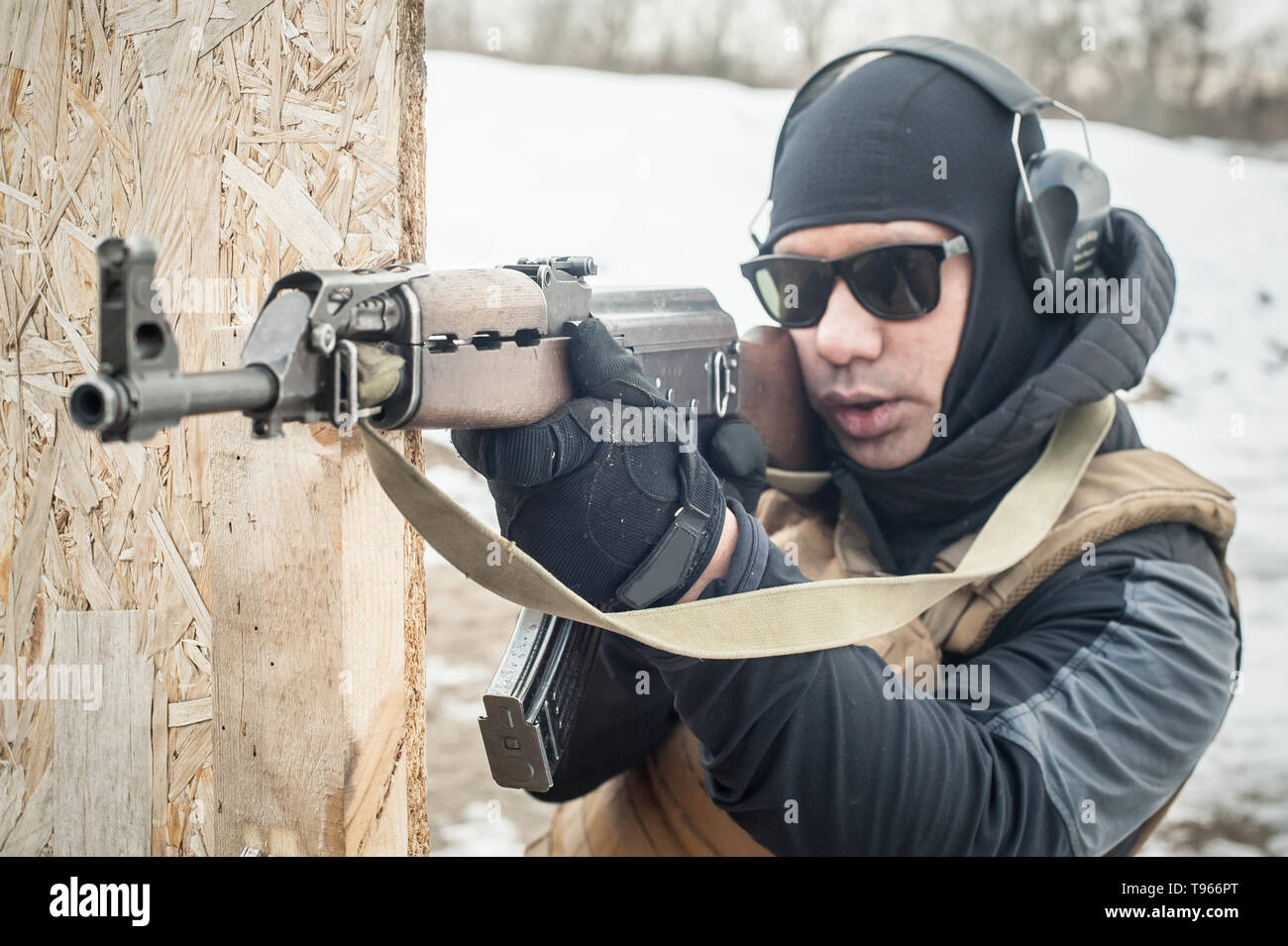 Special forces soldier in action, shooting from rifle machine gun ...