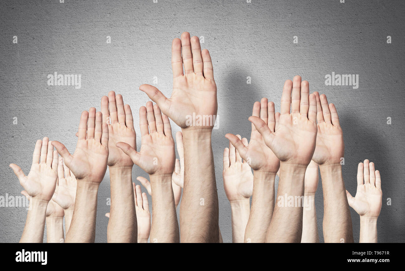 Row of man hands showing voting gesture Stock Photo - Alamy