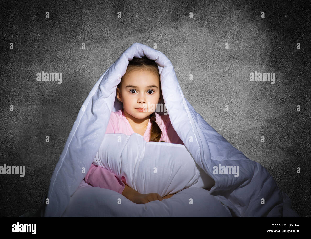 Frightened girl hiding under blanket Stock Photo - Alamy