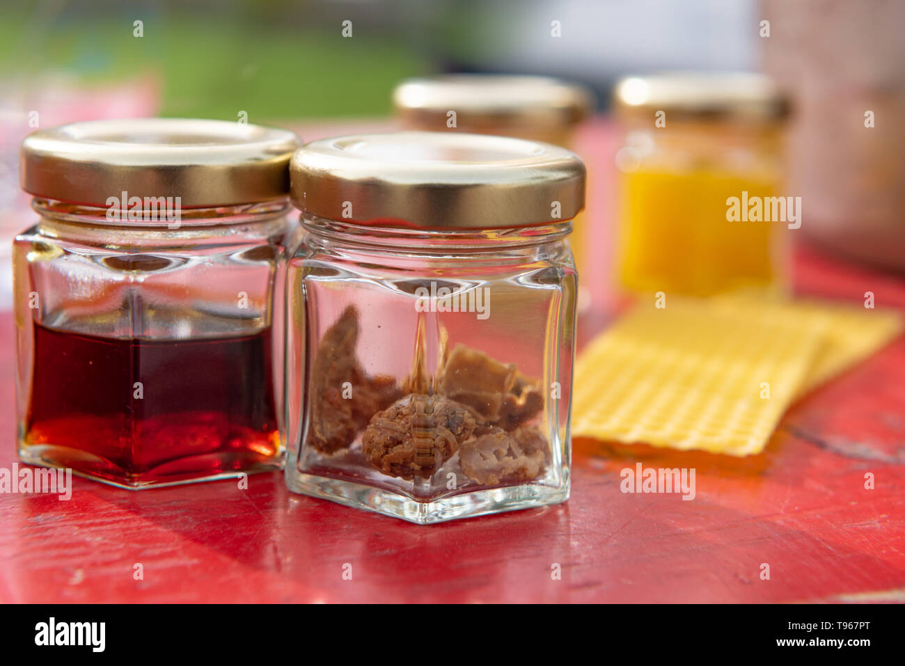 various products such as propolis, honey wax plates against blurred ...