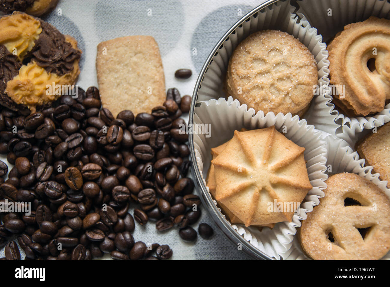 Cookies with sugar in a round box, partitioned with paper and coffee ...