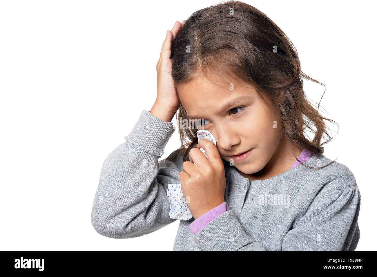 Sad little girl crying isolated on white background Stock Photo - Alamy