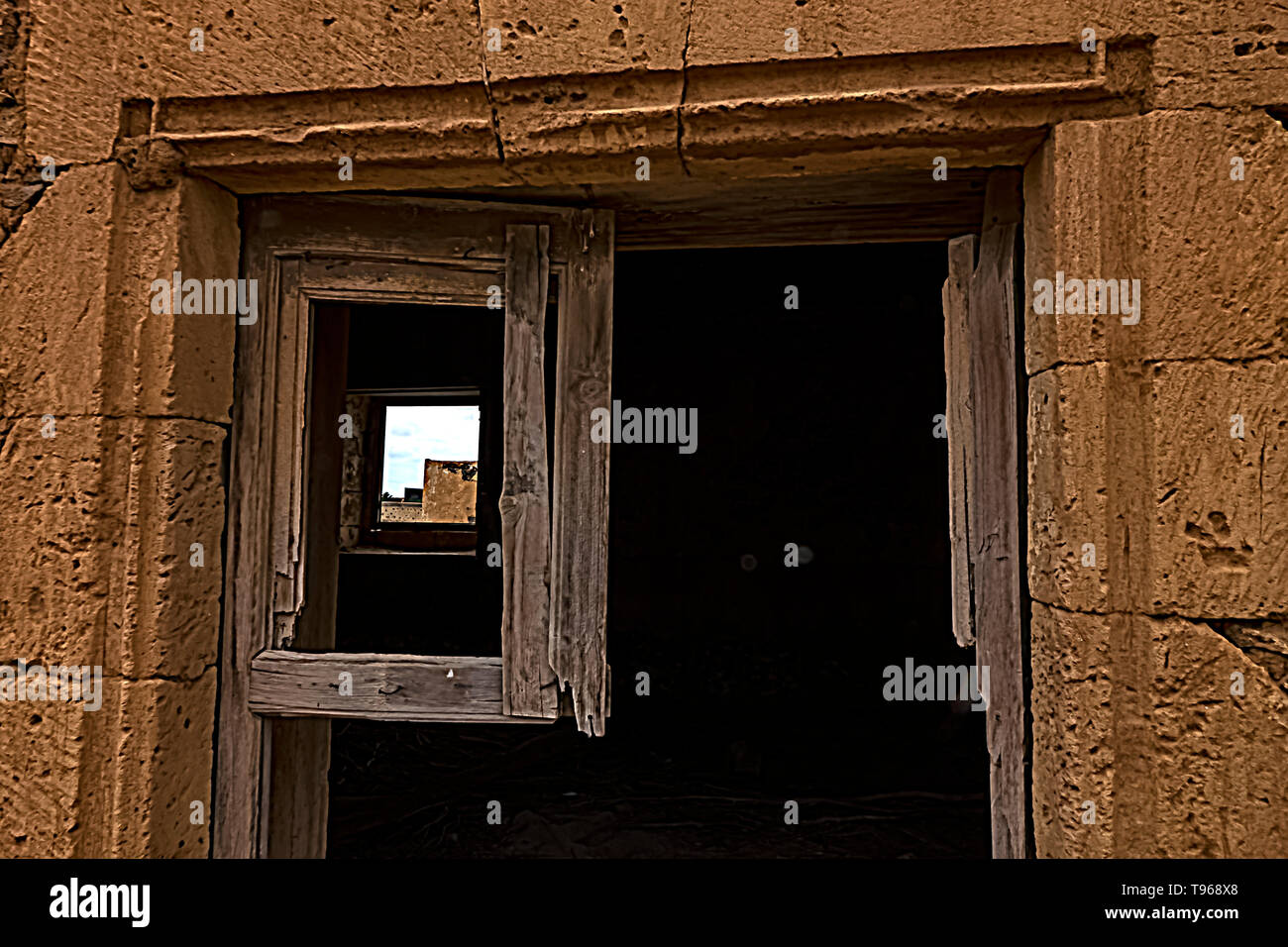 Ruin with broken wood window in a stone building creating an artistic ...