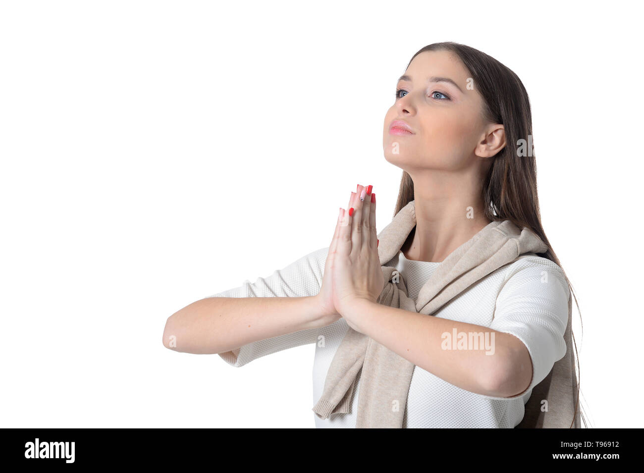 Portrait of beautiful young woman praying on white background Stock ...