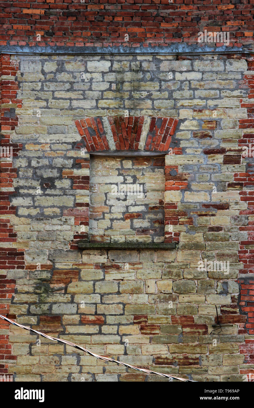 A fragment of an old brick and limestone historical building. Gatchina ...