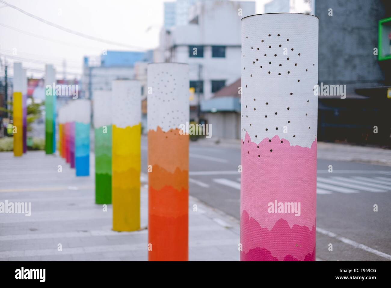 Colorful pillars on a sidewalk Stock Photo - Alamy