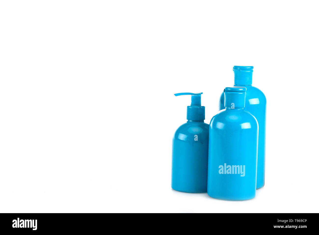 Blue cosmetic bottles with spray and caps isolated on white Stock Photo ...