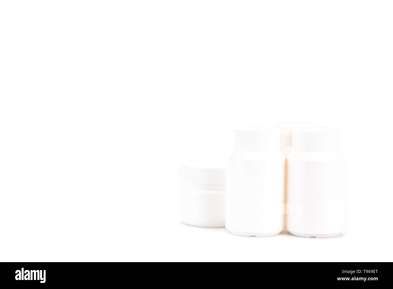 White cosmetic containers with caps isolated on white Stock Photo - Alamy