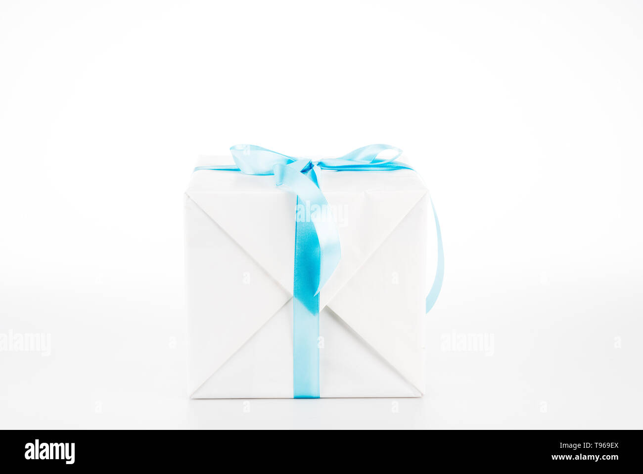 White gift box with blue ribbon on white Stock Photo - Alamy