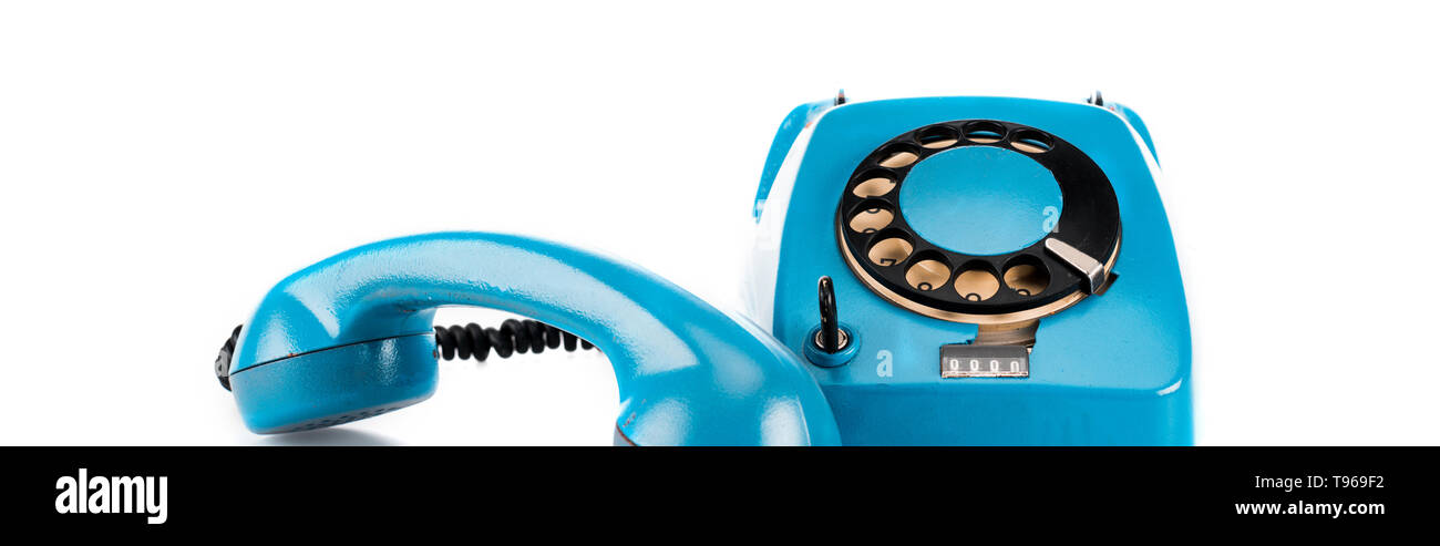 Panoramic shot of blue vintage telephone with handset and wire on white ...