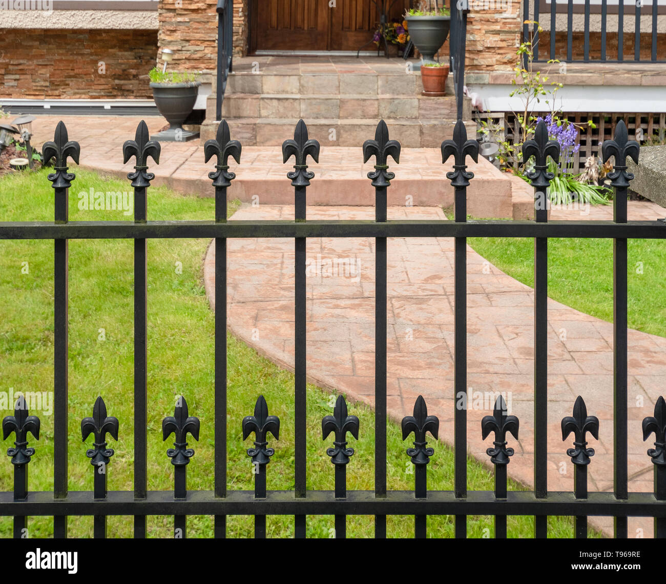 Black metal grid fence of residential house with lily shaped tops Stock ...