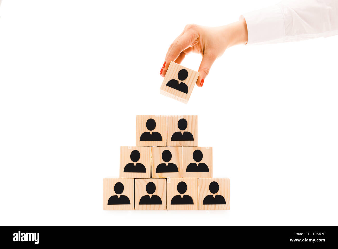 cropped view of woman picking up one wooden block with black human icon ...