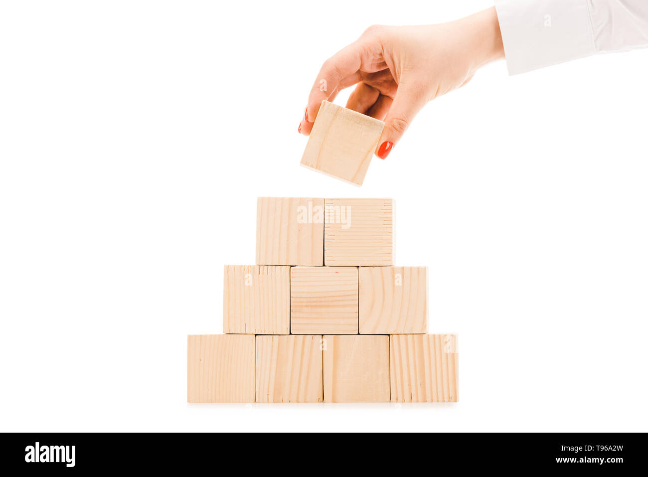 partial view of woman picking up one wooden block with copy space from ...