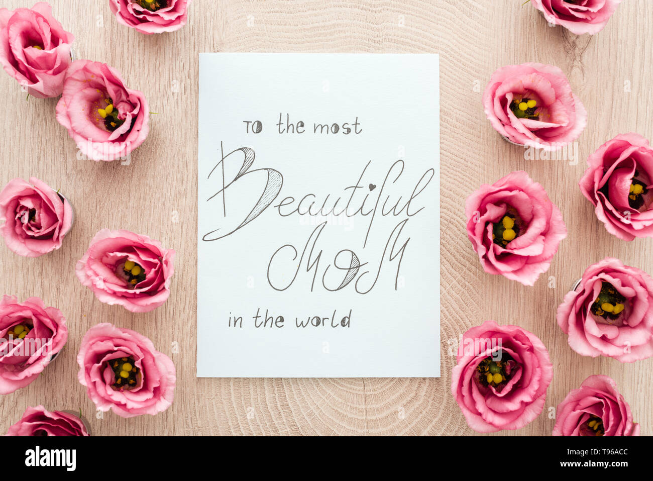 top view of eustoma flowers and card with to the most beautiful mom in ...