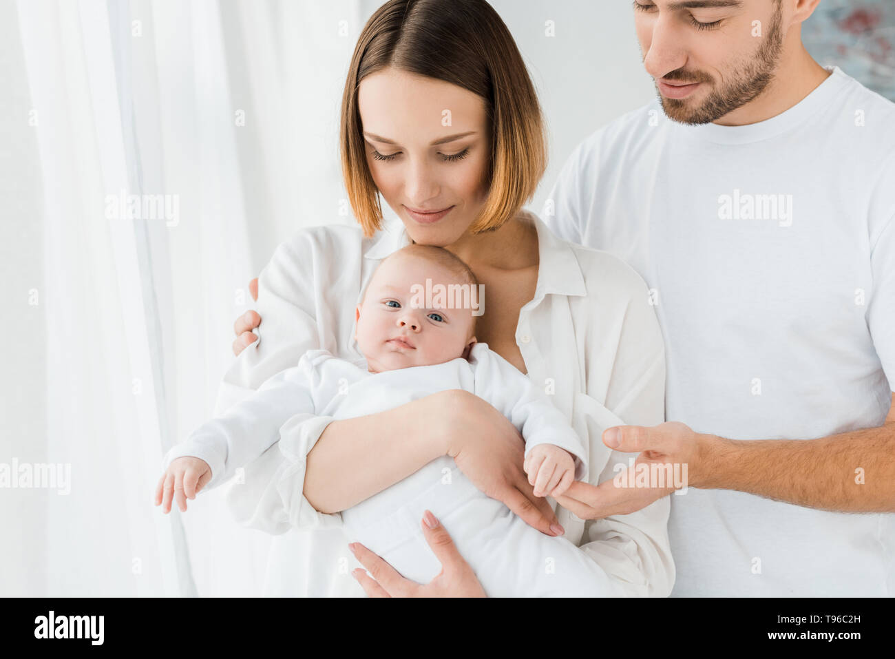 cropped view of happy family with baby at home Stock Photo - Alamy