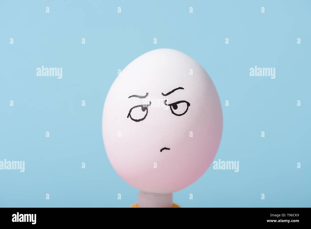 egg with angry face expression isolated on blue Stock Photo - Alamy
