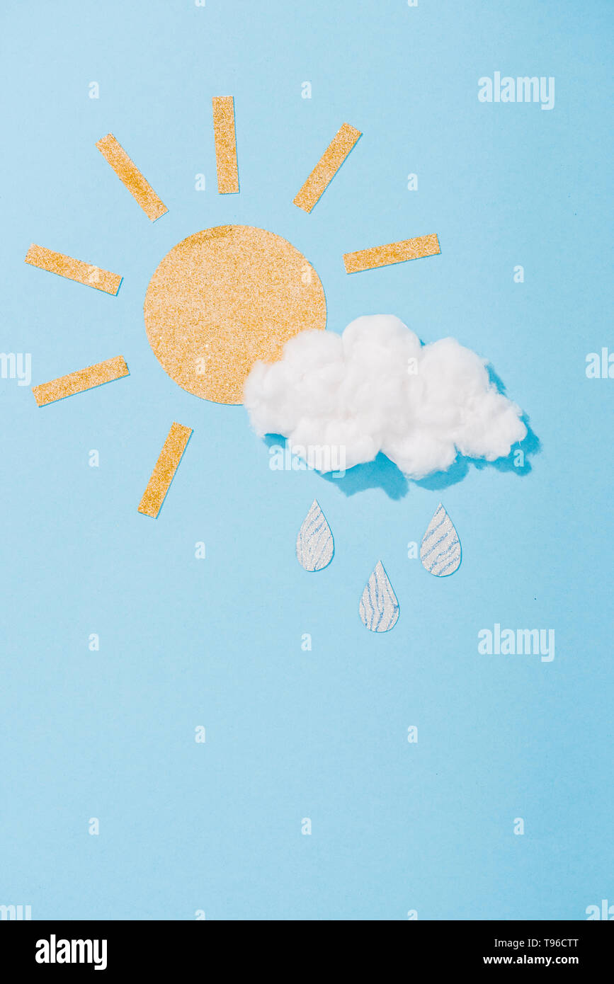 paper sun and cotton candy cloud with glitter raindrops on blue Stock ...