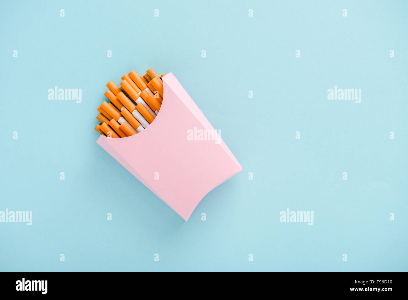 top view of cigarettes packed in paper box isolated on blue with copy ...
