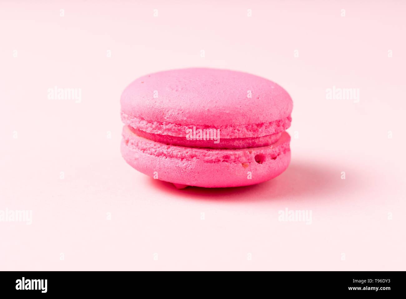 bright macaron cookie with filling on pink surface Stock Photo - Alamy