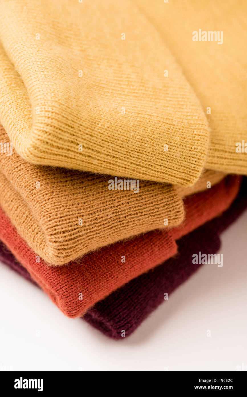 stack of folded colorful clothes on white surface Stock Photo - Alamy