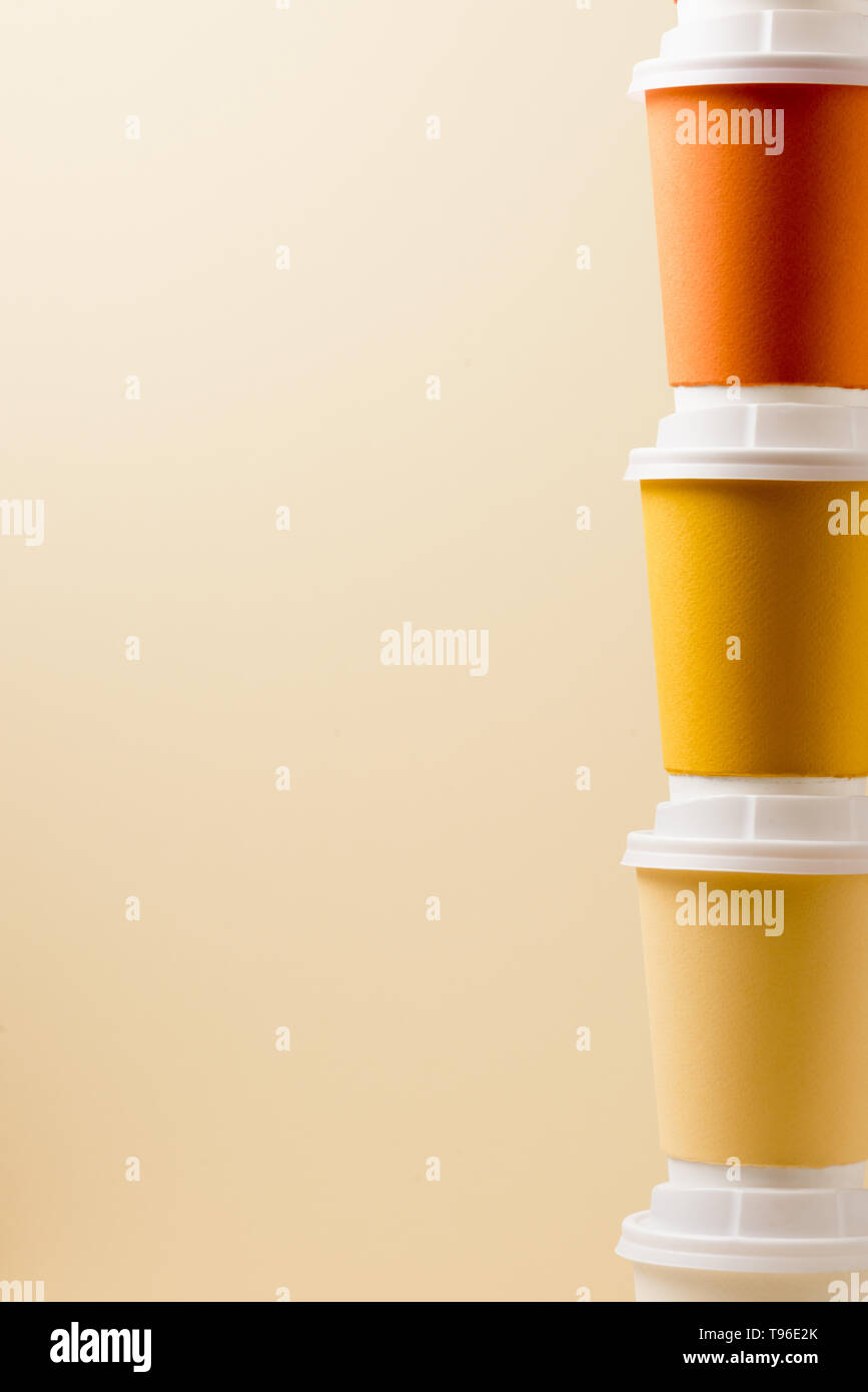 colorful disposable cups with white caps isolated on beige Stock Photo ...