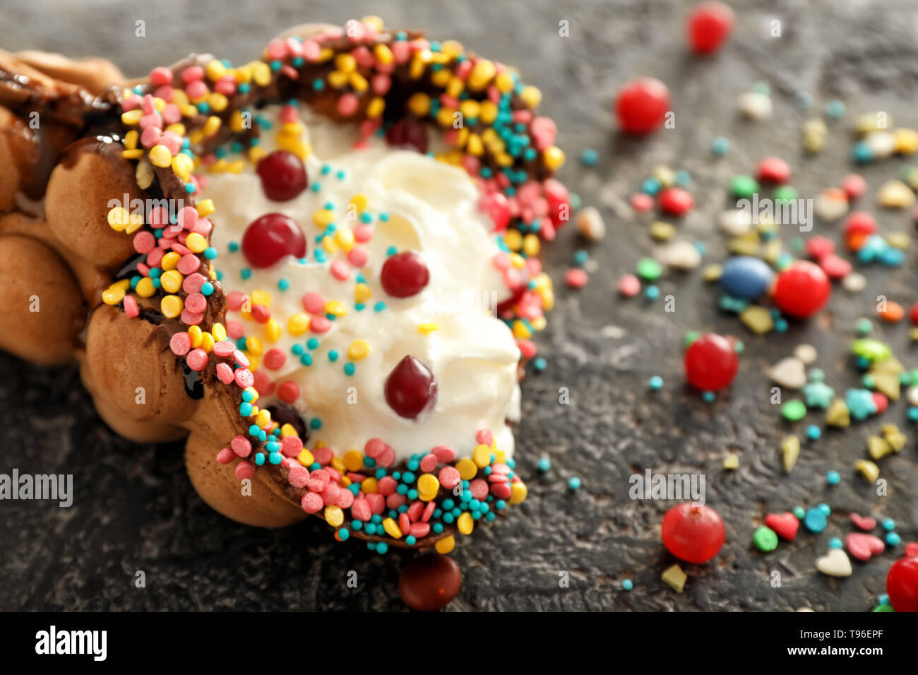 Delicious sweet bubble waffle with sprinkles on grey background Stock ...