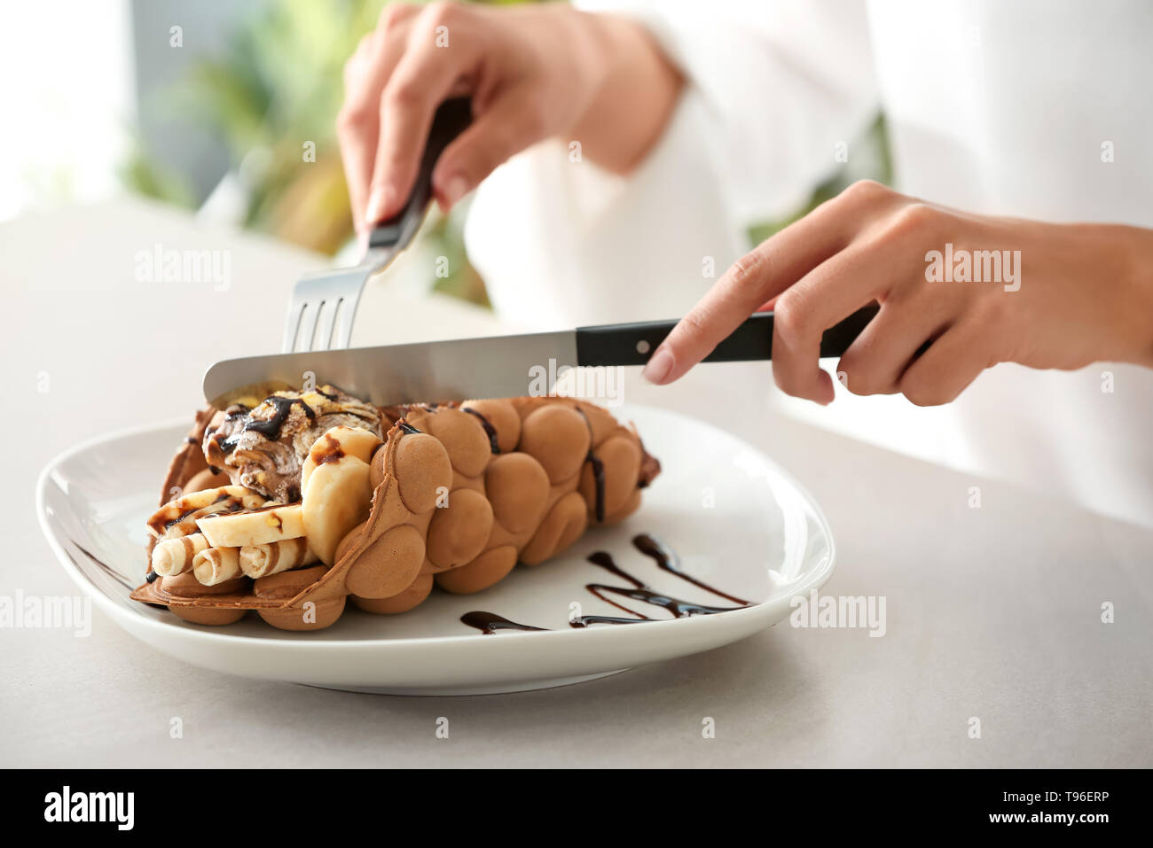 Woman eating chocolate wafer hi-res stock photography and images - Alamy
