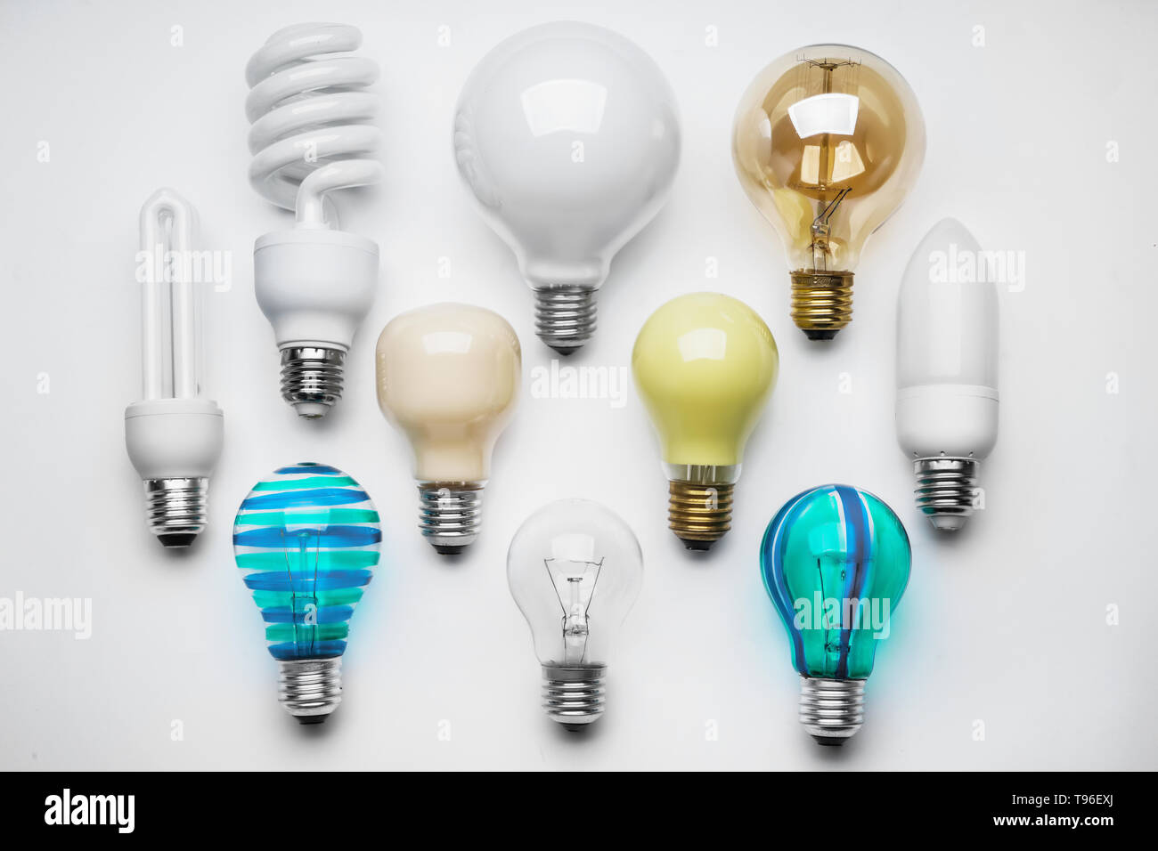 Composition with different light bulbs on white background Stock Photo ...
