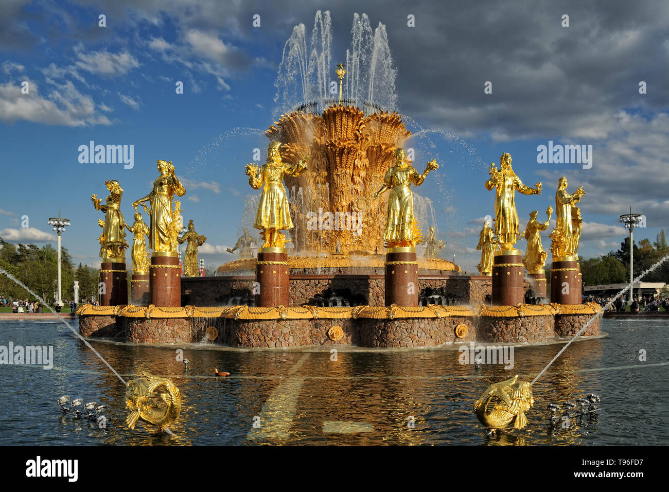 = Shining Gold Friendship of Nations Fountain Against Grey Clouds ...