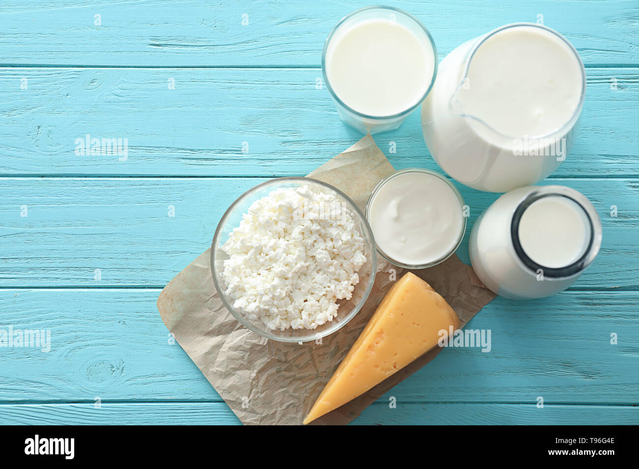 Different milk products on color wooden table Stock Photo - Alamy