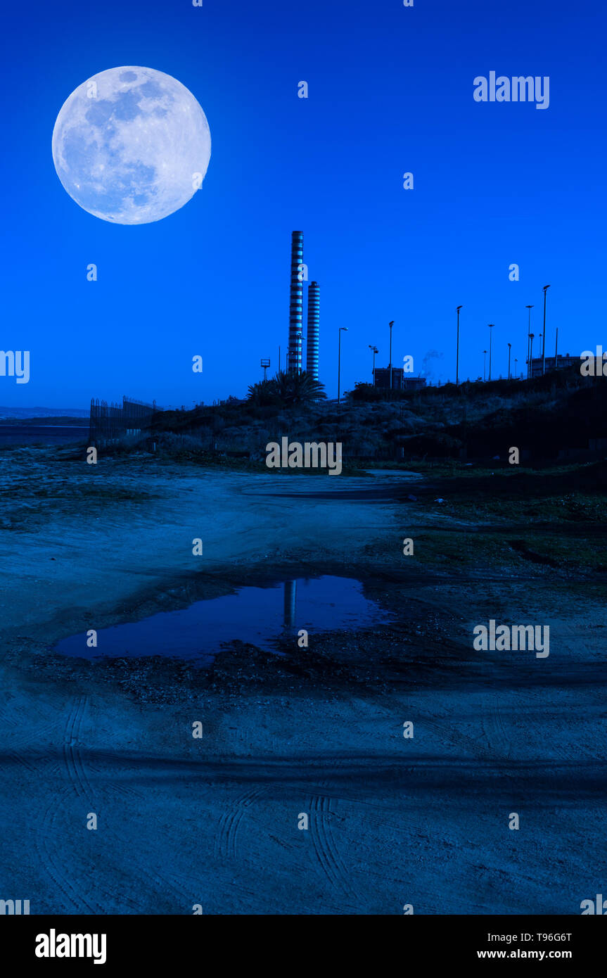 chimney on the sea at night under the super moon Stock Photo - Alamy