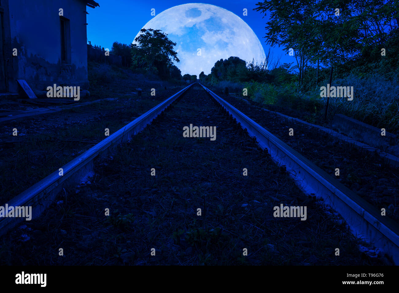 country railway at night to the super moon Stock Photo - Alamy