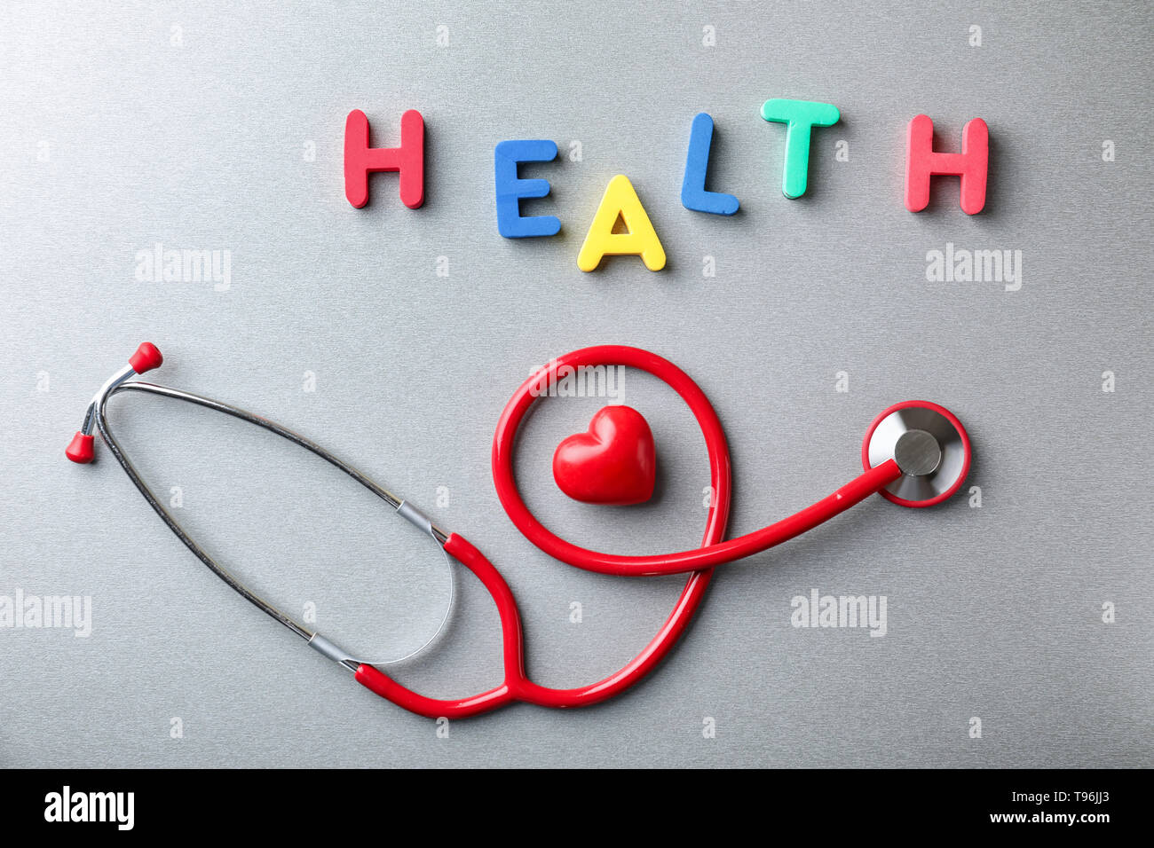 Word HEALTH made of colorful letters with stethoscope on grey ...