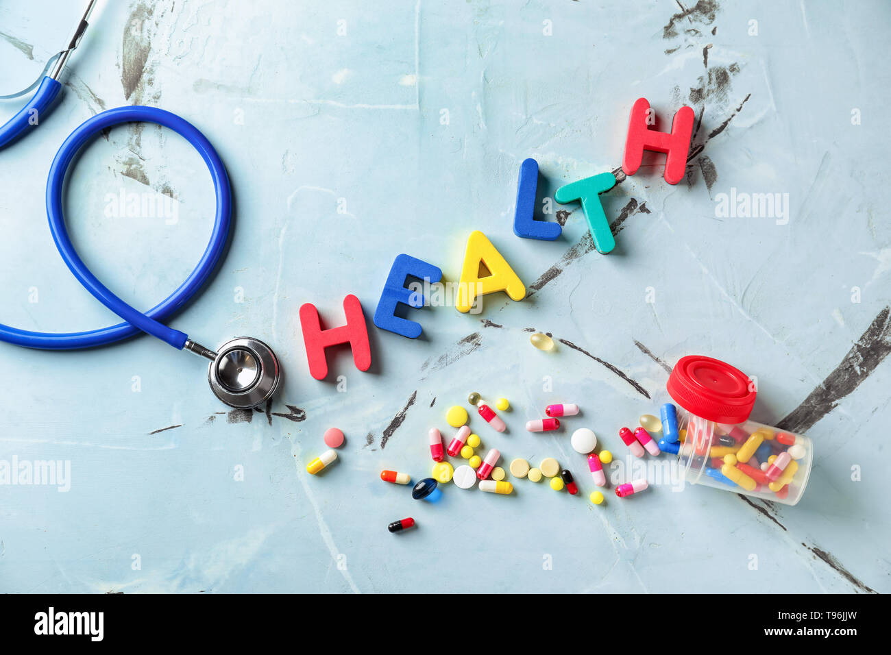 Word HEALTH made of colorful letters with stethoscope and pills on ...