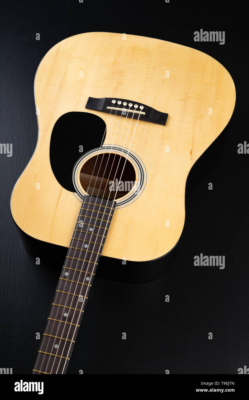 Classical guitar on a dark wooden table. Musical instrument stringed ...