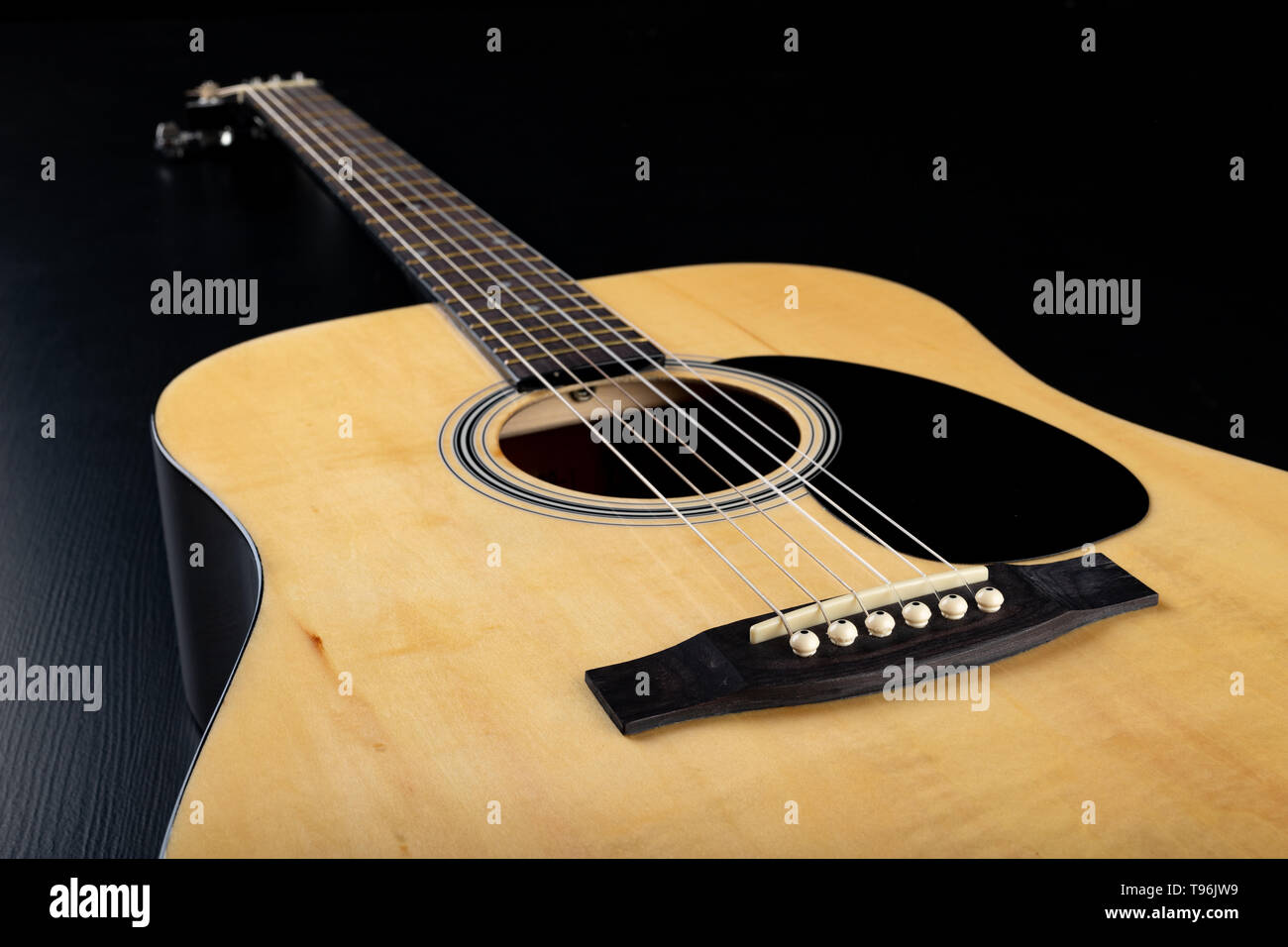 Classical guitar on a dark wooden table. Musical instrument stringed ...
