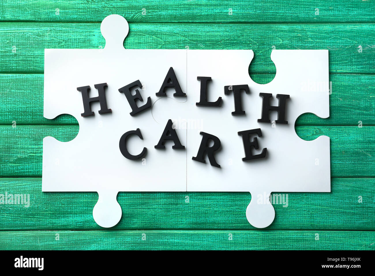 Text HEALTH CARE made of dark letters with pieces of puzzle on color ...