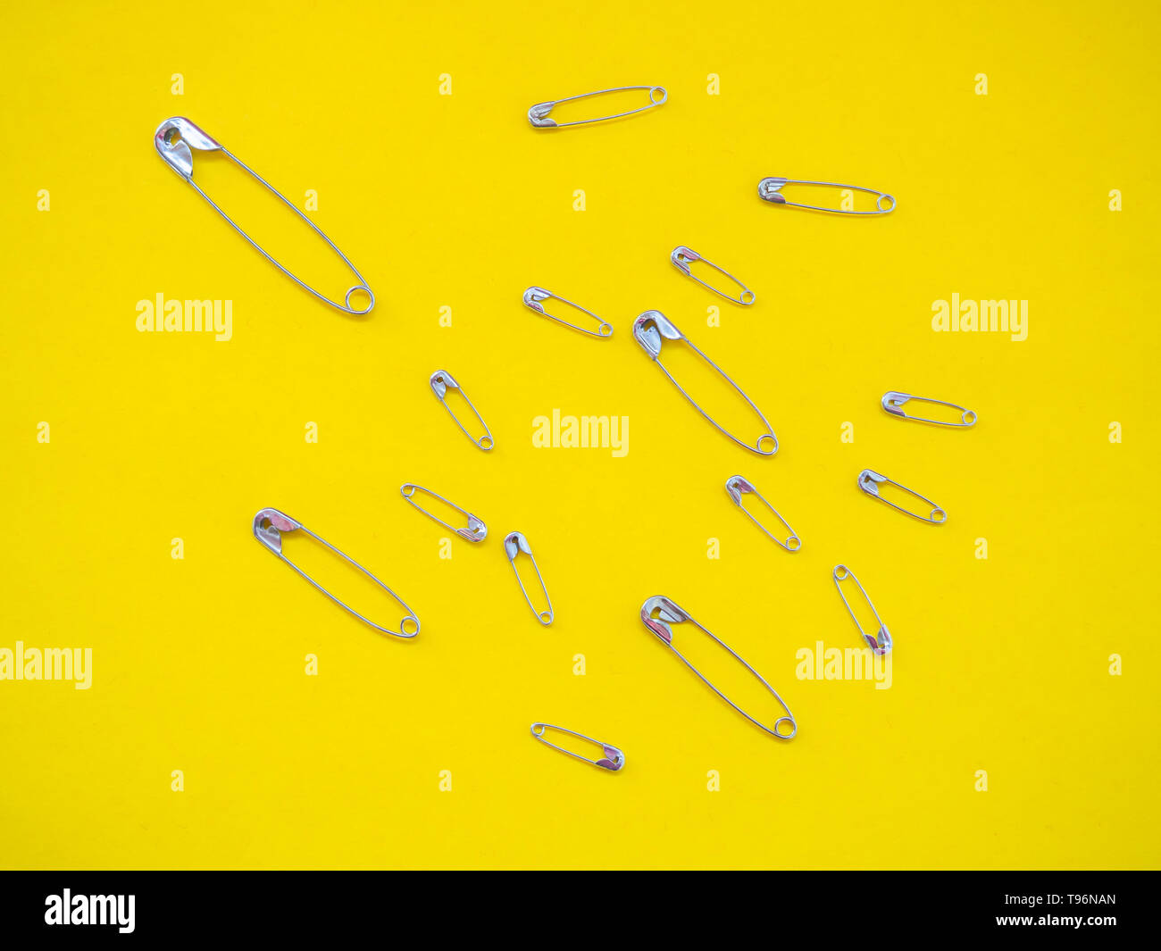 A large safety pin followed by other smaller ones in human ...