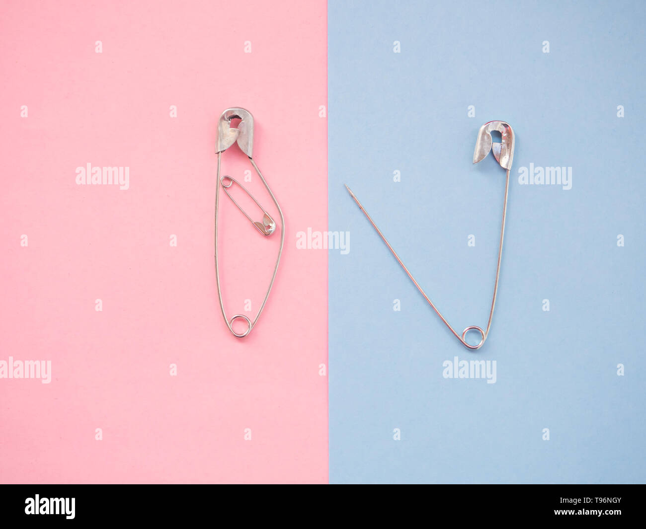 Several safety pins of various sizes in human representation. Concept ...