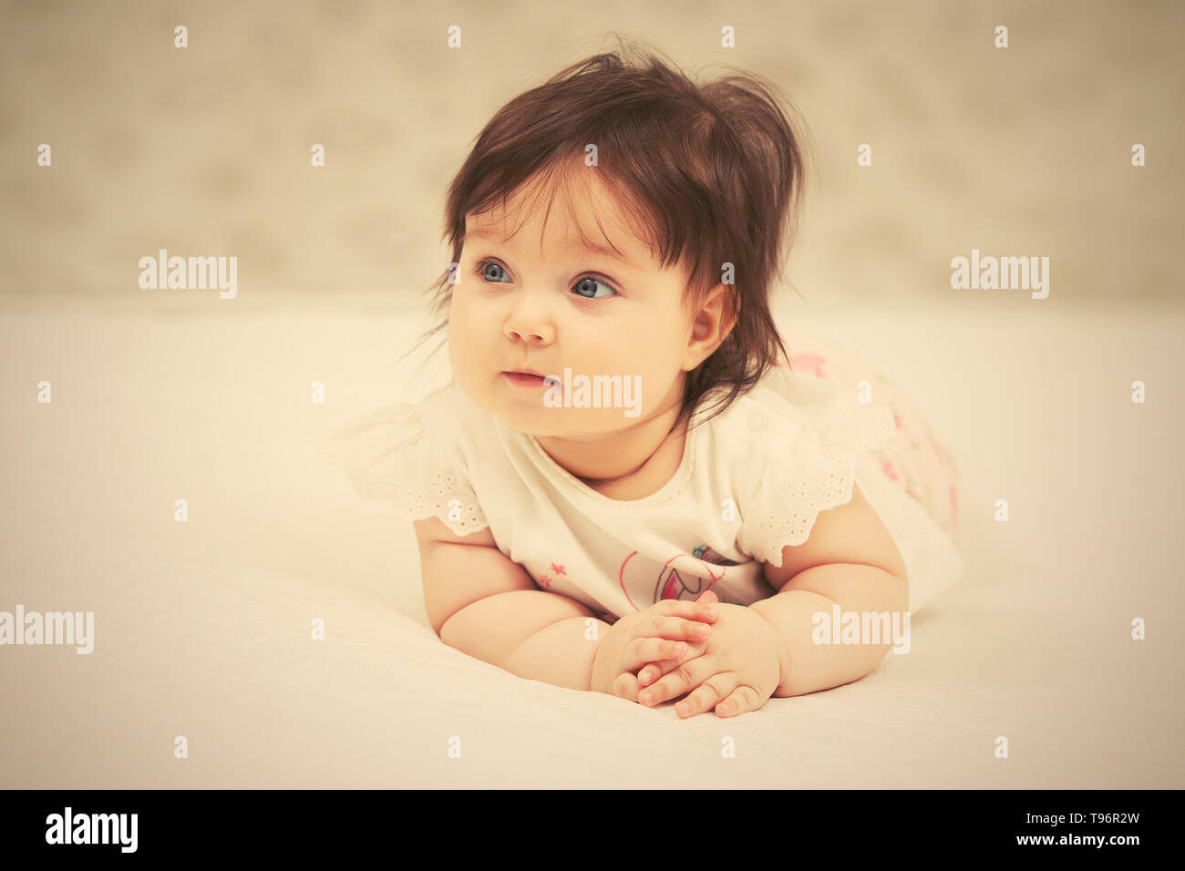 Happy half year baby girl lying on blanket at home Stock Photo - Alamy