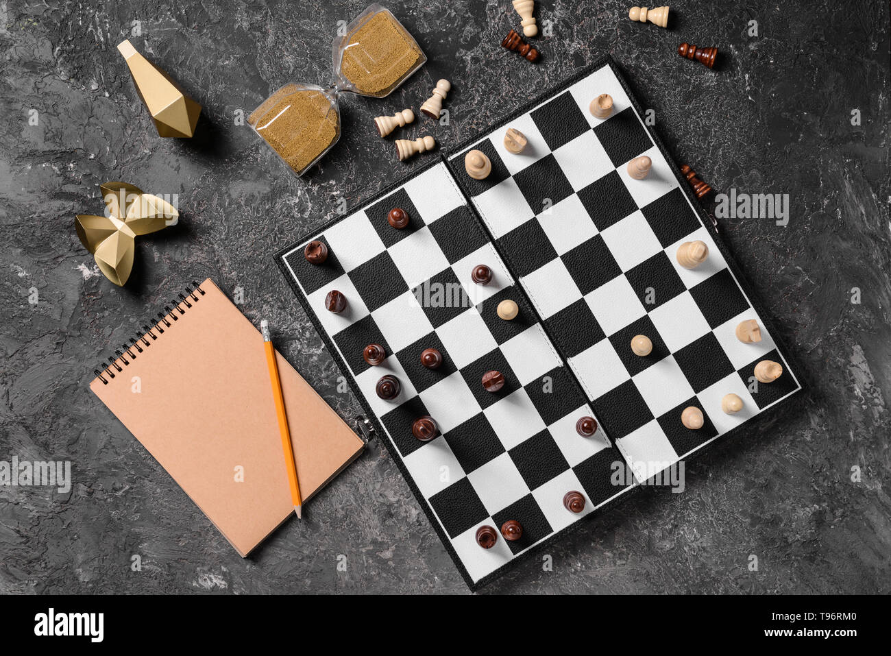 Composition with chess pieces and game board on grey background Stock ...