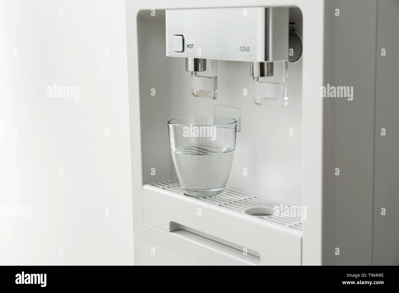 Modern water cooler with glass on white background Stock Photo - Alamy