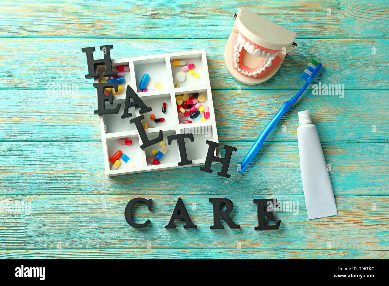 Text HEALTH CARE made of dark letters with pills and artificial jaw on ...