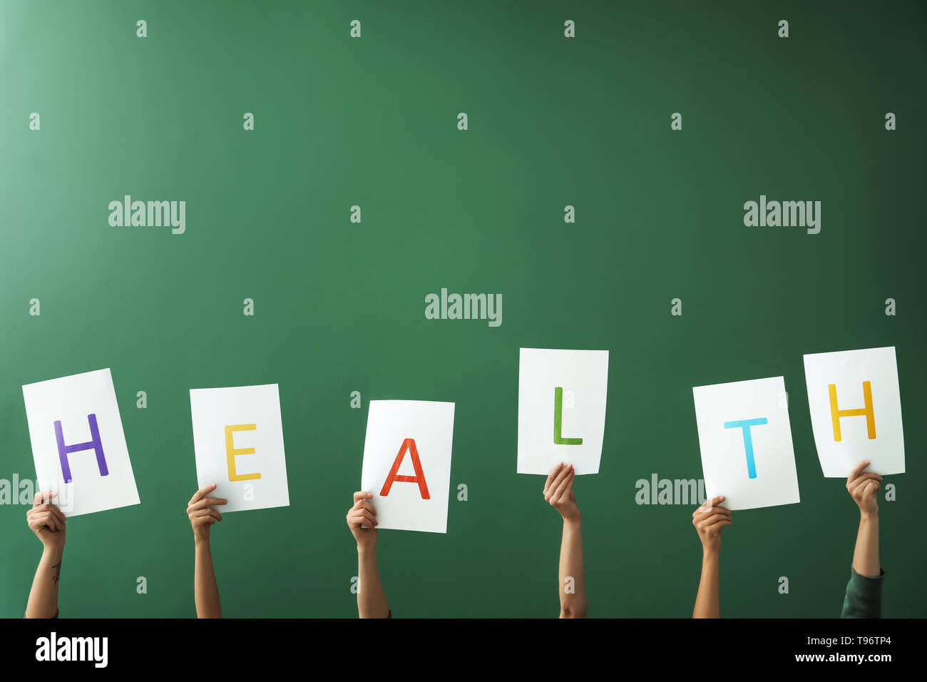 Female hands with letters forming word HEALTH on color background Stock ...